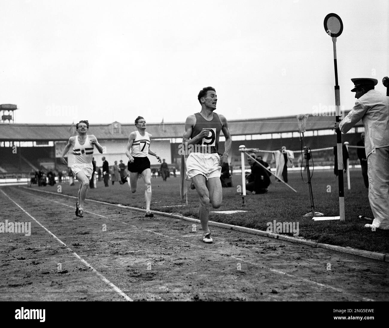 Hungarian athlete Laszlo Tabori crosses the line in the mile race in ...