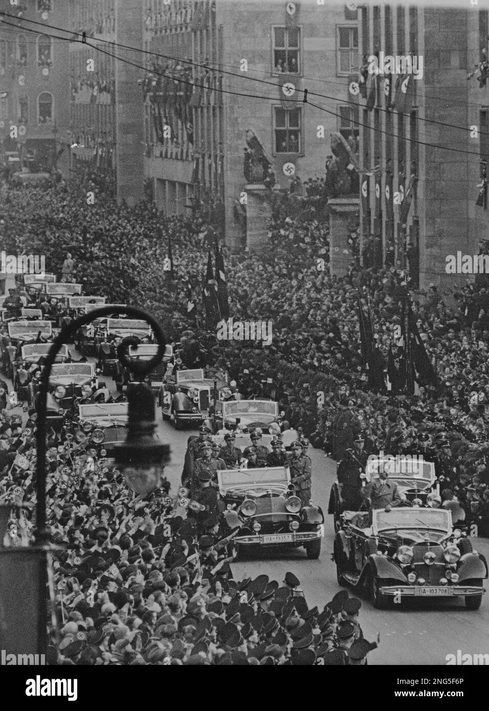 Adolf Hitler is seen leading a motorcade down Wilhelmstreet on ...