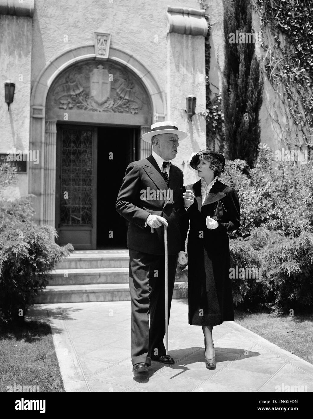 Director D.W. Griffith, left, arrives with his wife, for the funeral of ...
