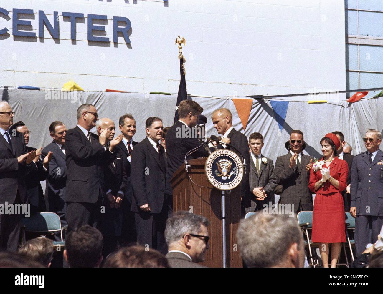 President John F. Kennedy, at podium, pins astronaut John Glenn with ...