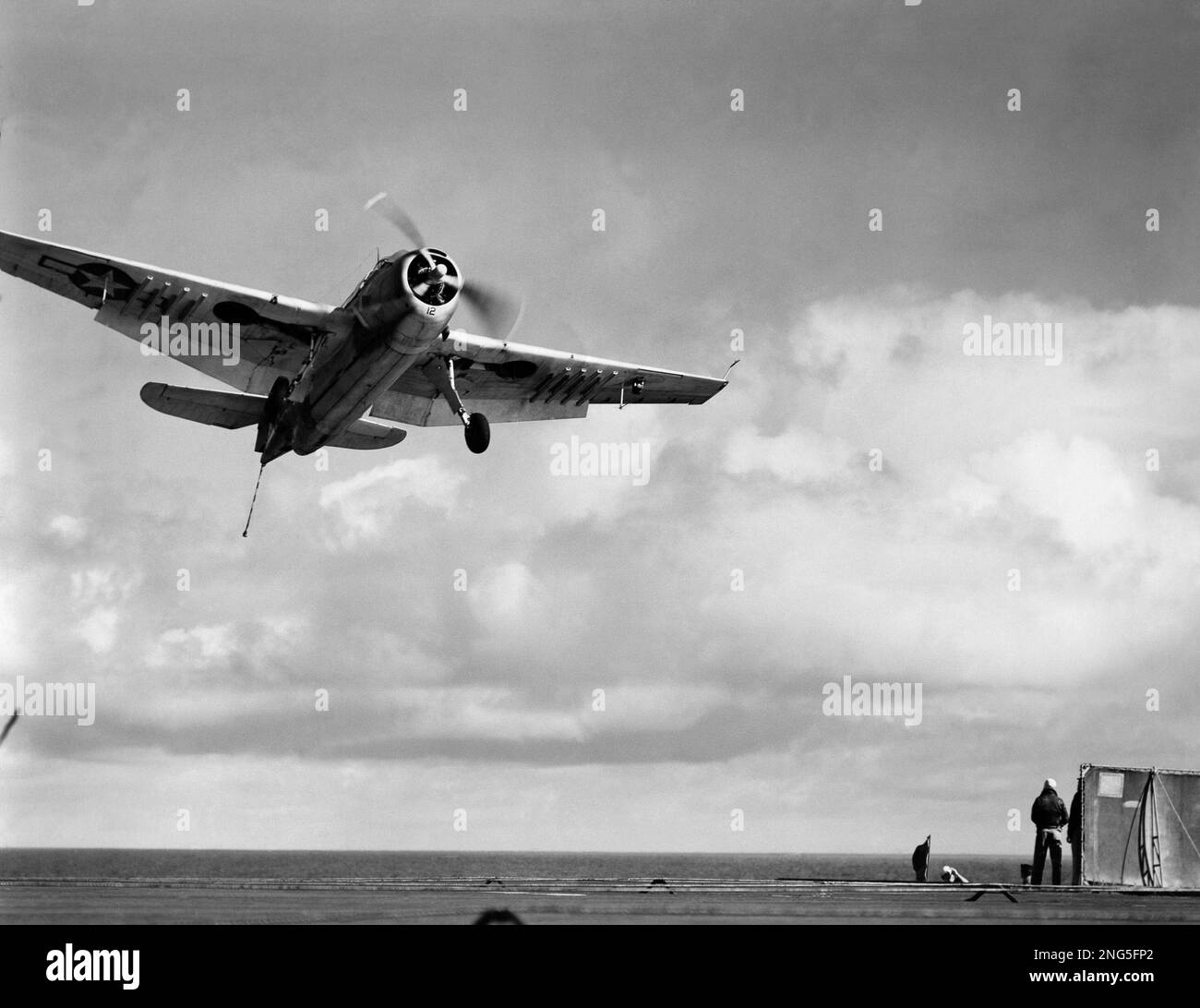 A U.S. Navy Avenger torpedo bomber returns to the flight deck of its ...
