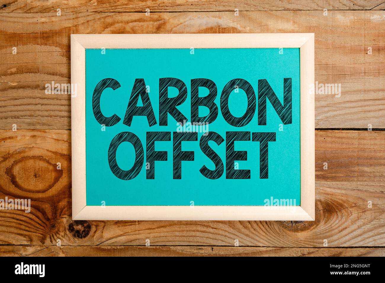 Hand writing sign Carbon Offset. Word Written on Reduction in emissions ...