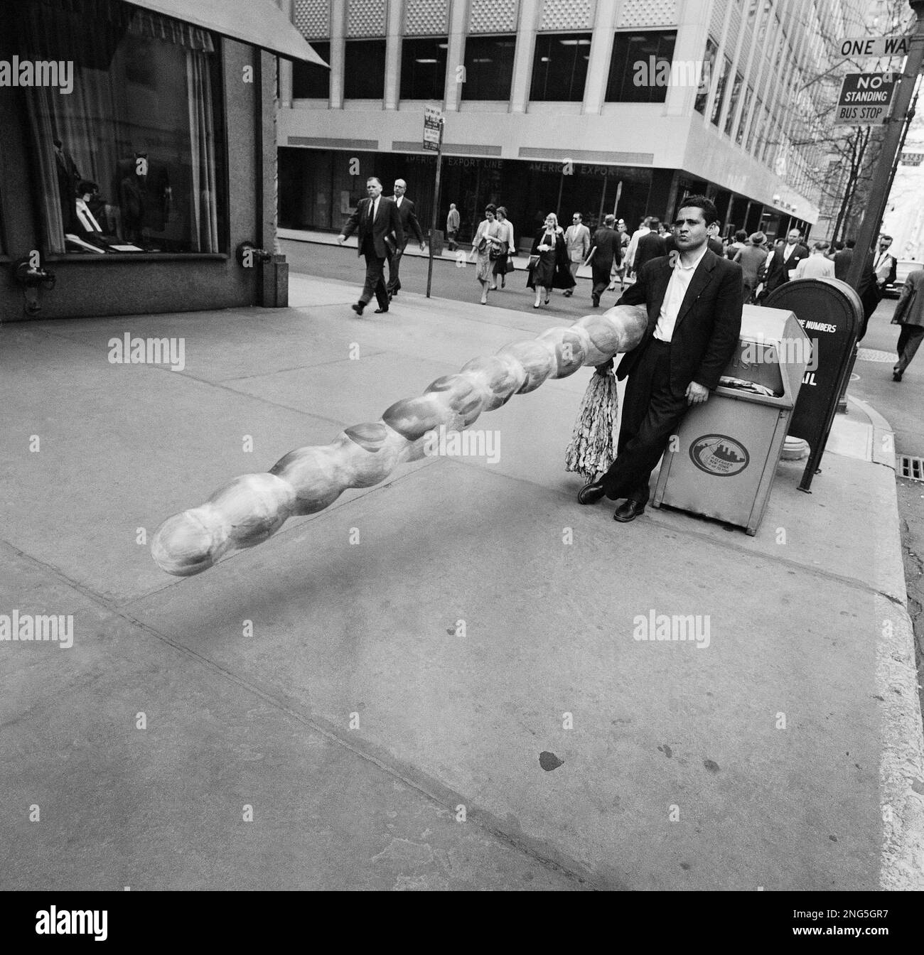 Holding a sample of his product, a balloon which stretches in a long ...