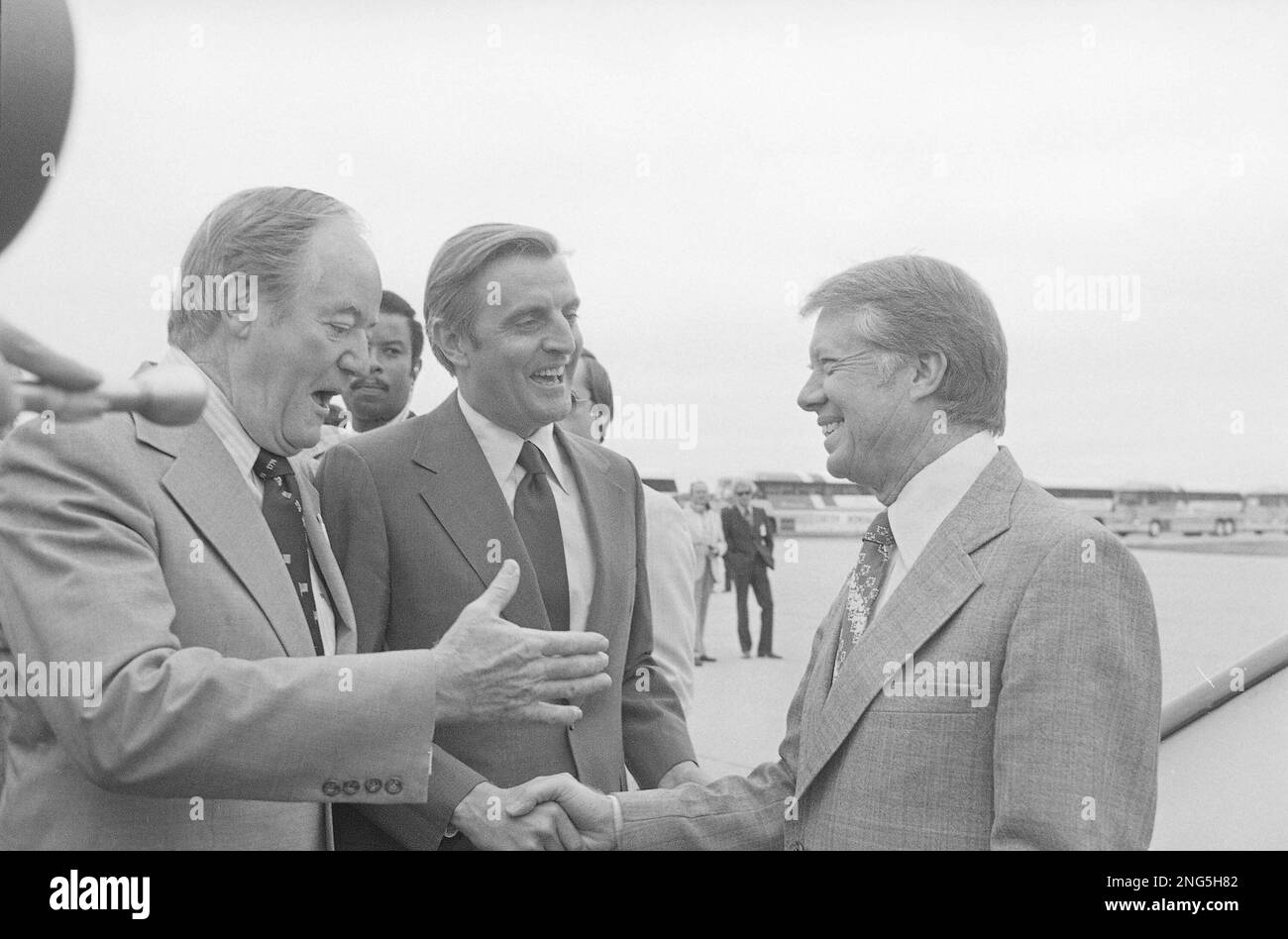 Sen. Hubert Humphrey, left, looks down in awe with an empty ...