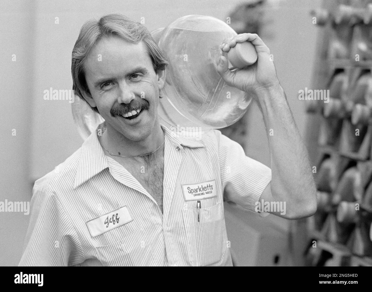 Jeff Fenn, 26, a truck driver, carries a bottle of distilled water over his shoulder Monday ...
