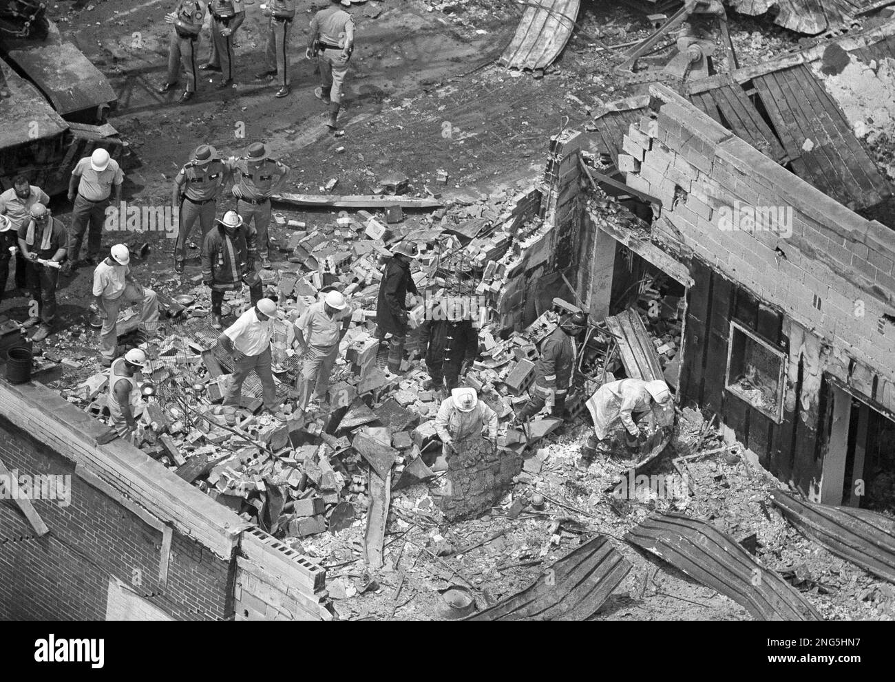 Firemen pick through the remains of the gutted Beverly Hills Supper ...