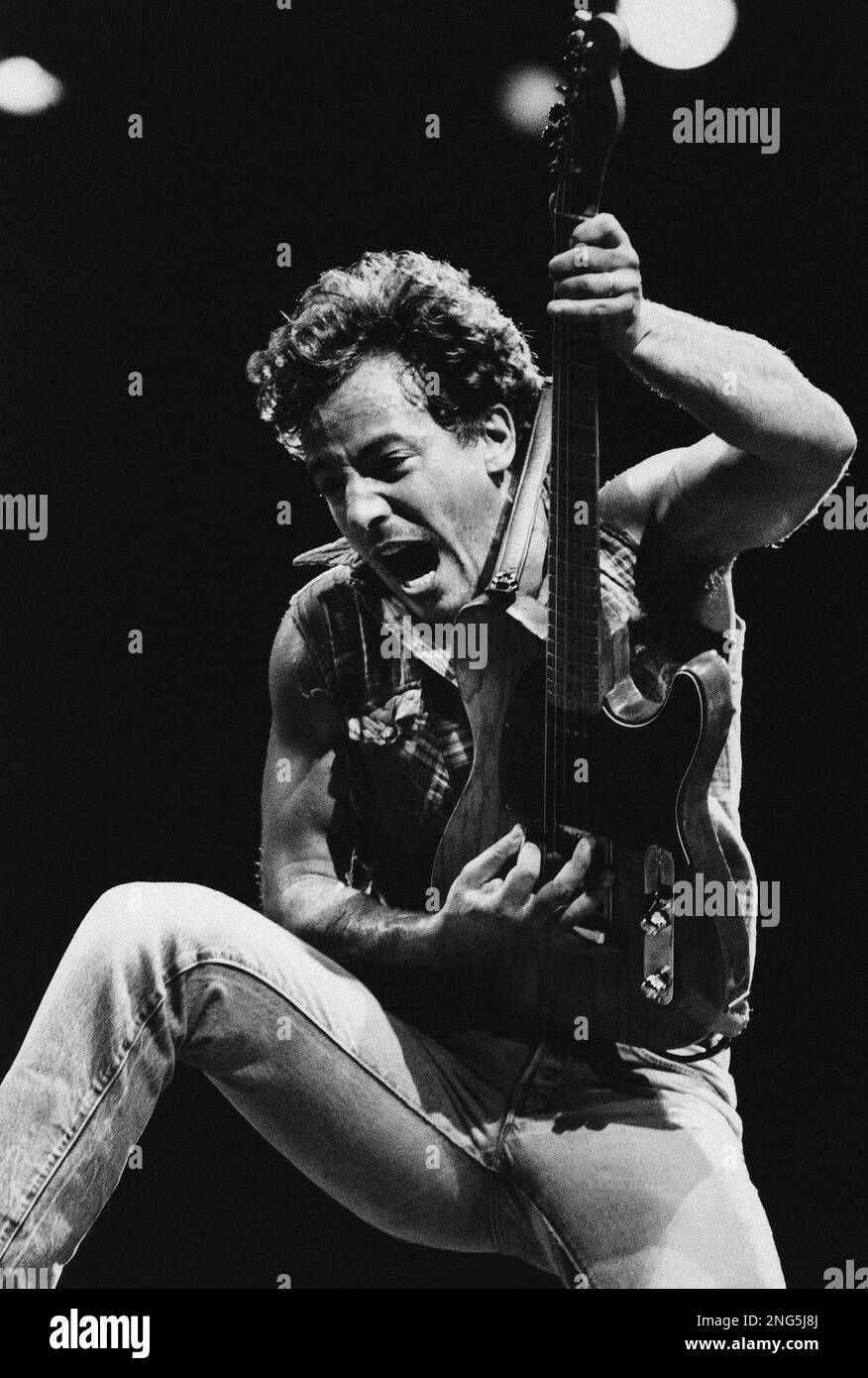 Rock star Bruce Springsteen belts out a song for fans at a concert at ...