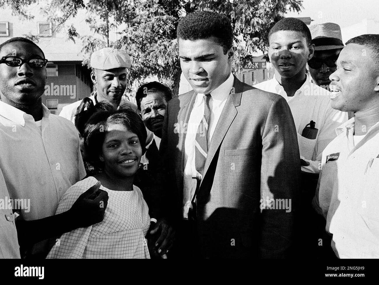 Heavyweight boxer Muhammad Ali is surrounded by admirers and friends ...