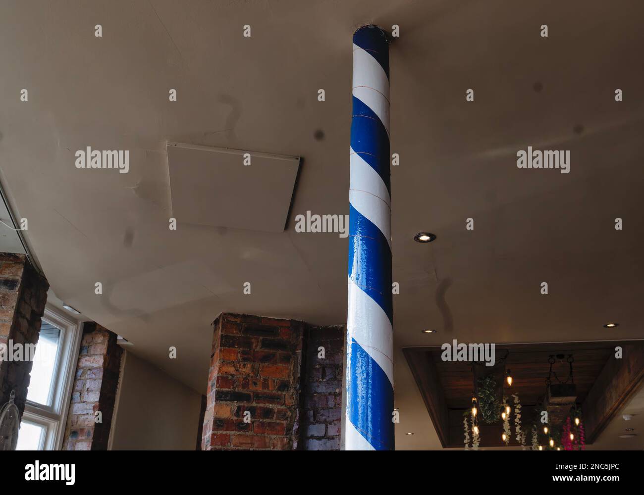 Pole holding up the ceiling in a restaurant Stock Photo - Alamy
