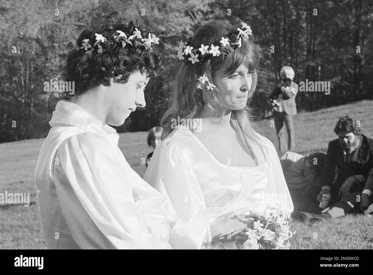 Arlo Guthrie and his bride, Jackie Hyde, listen to a folk song during ...