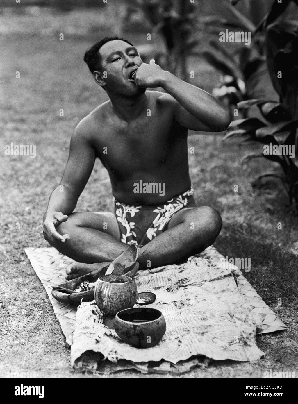 In this undated photo, native of Hawaii eating poi, taro root boiled to ...