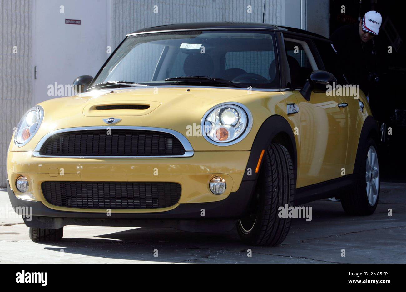 A buyer looks over the back of a 2007 Mini Cooper S after the new ...