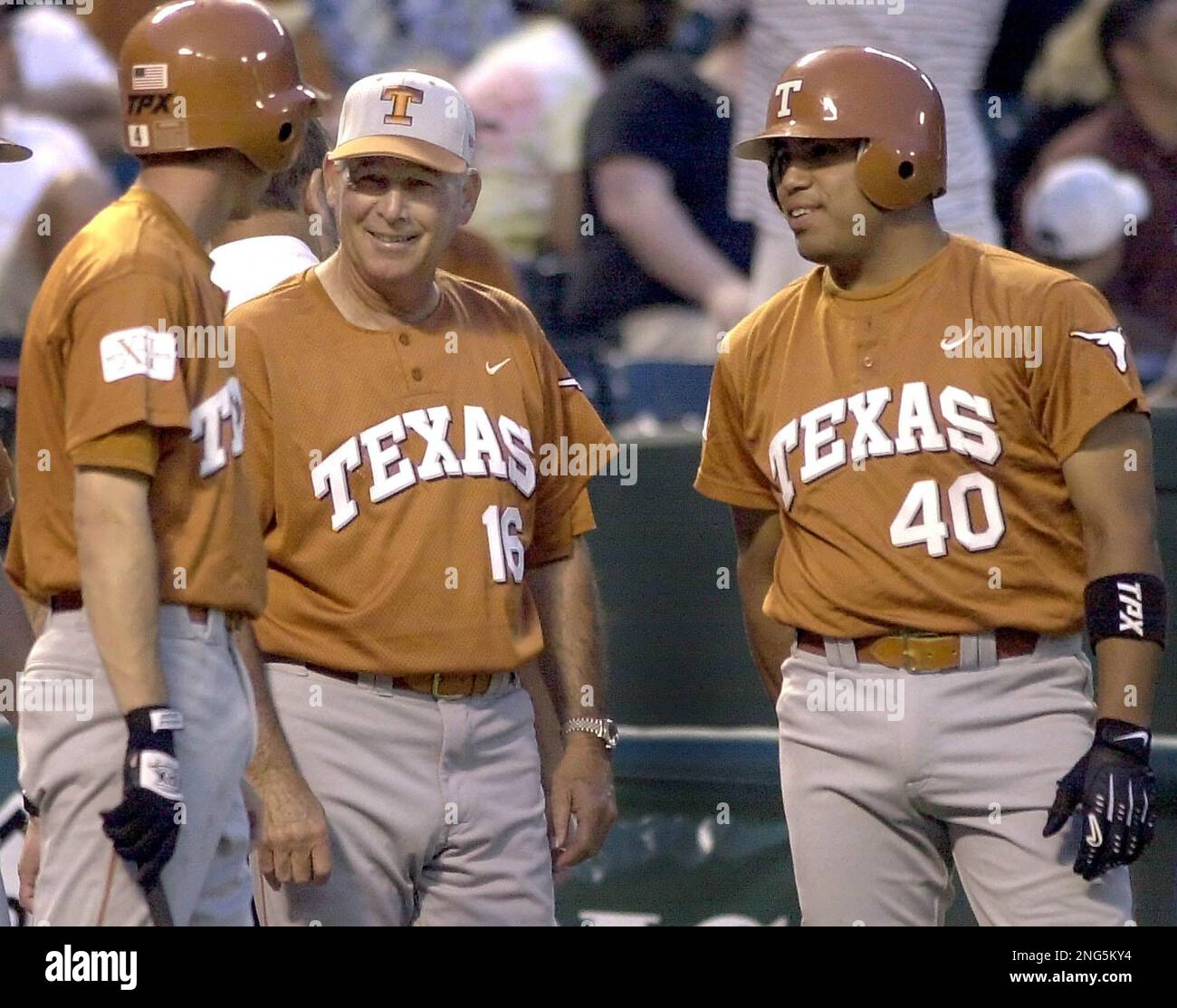 Texas coach Augie Garrido (16) shares a laugh with Brandon Fahey, left ...