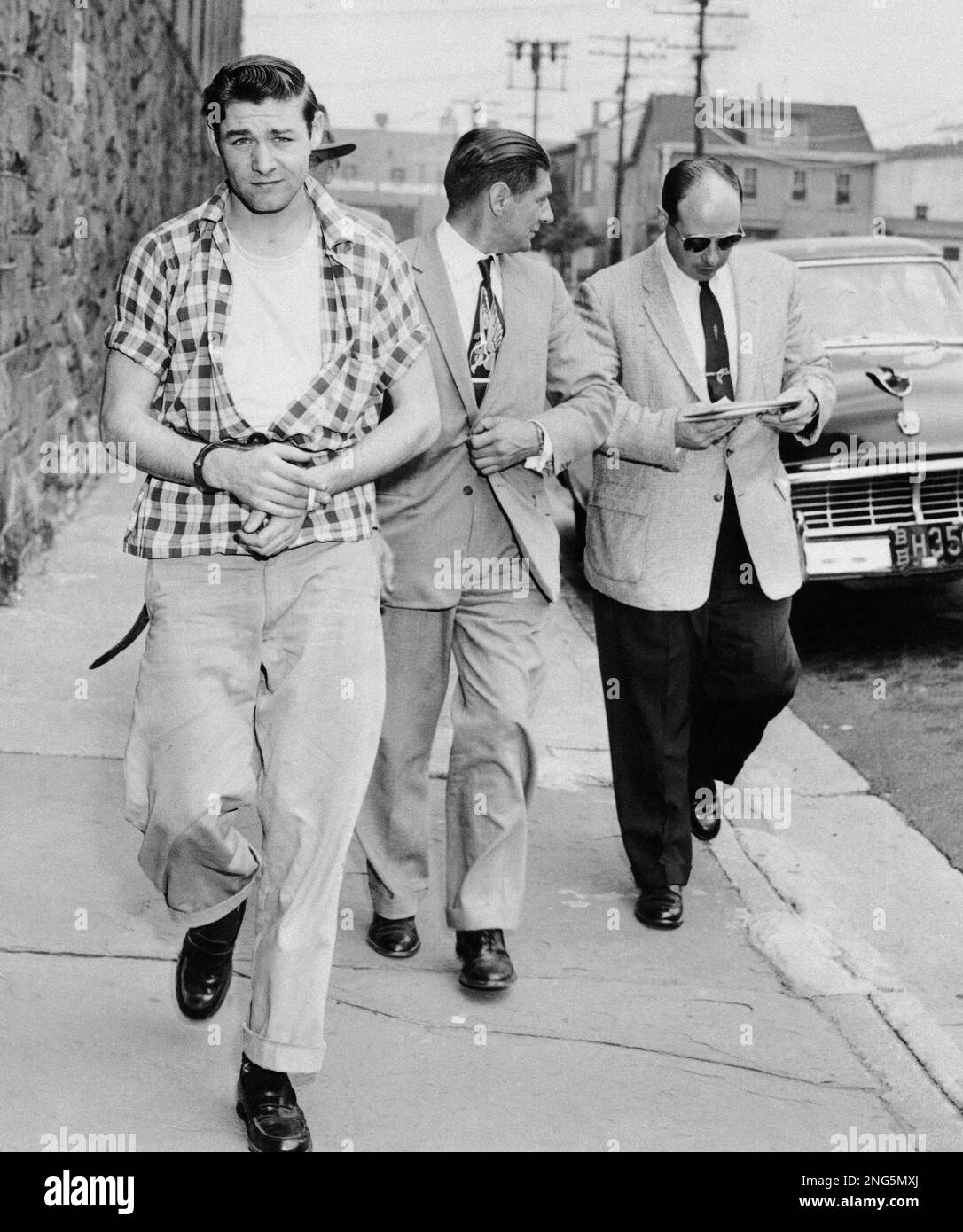 Edgar Smith, handcuffed and holding cigarette, walks to gate of New ...