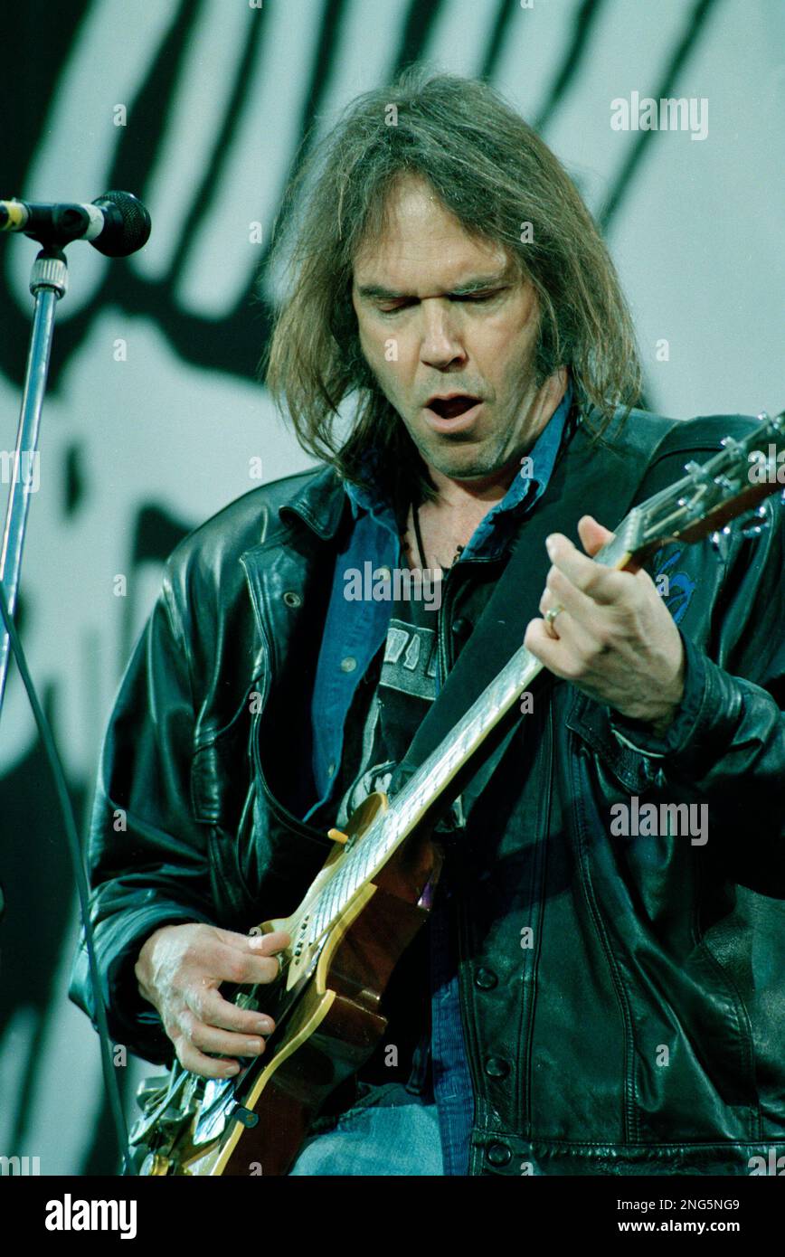 Veteran rock 'n roller Neil Young performs on stage at London's Wembley ...