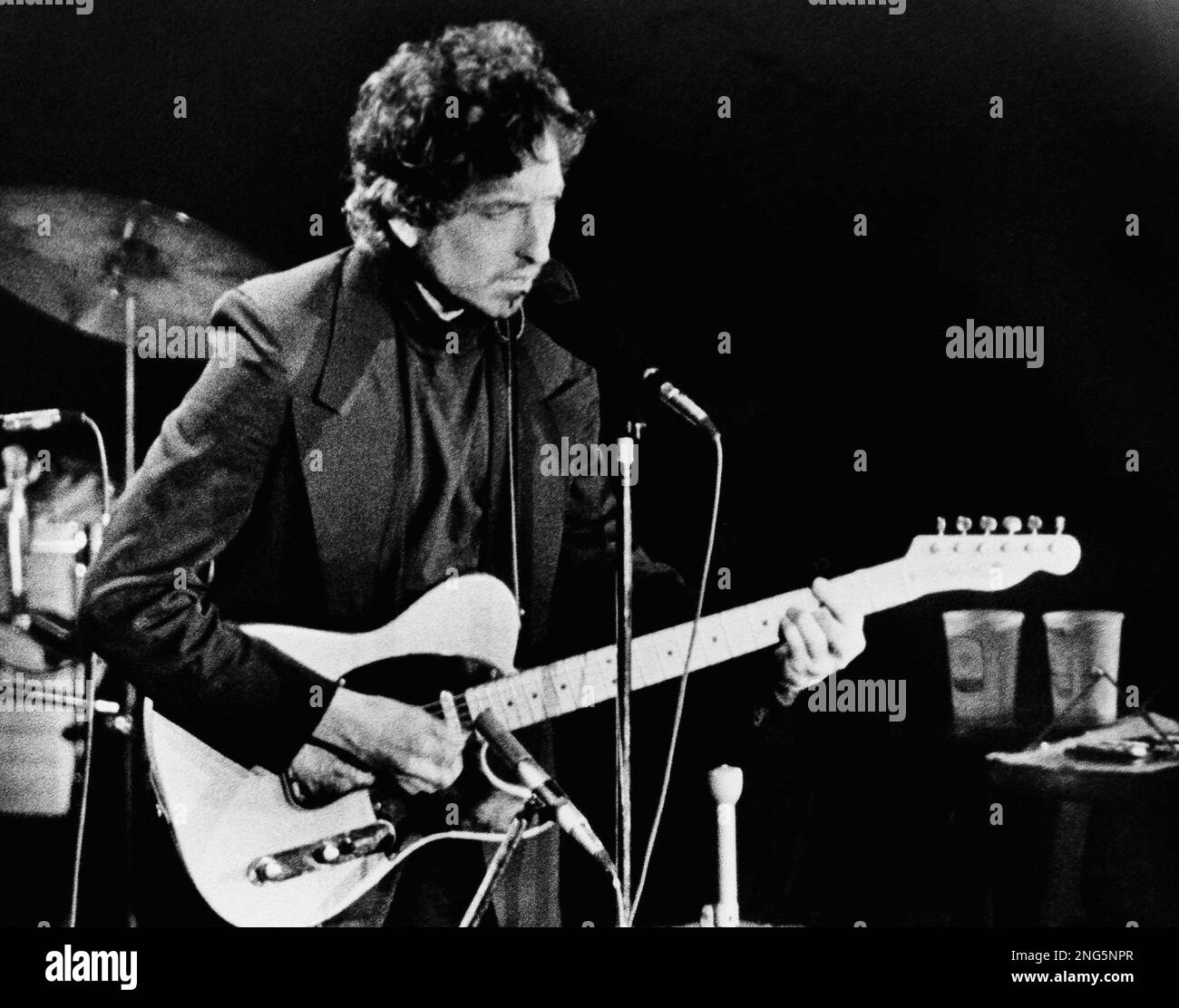 Singer Bob Dylan strums his Fender Telecaster guitar to the delight of ...