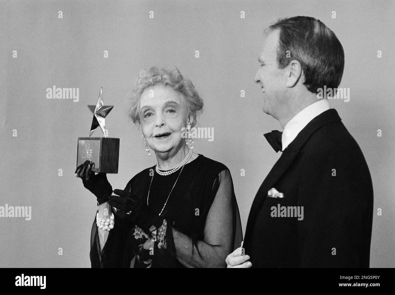 Actress Lillian Gish holds up her Life Achievement Award as she stands ...