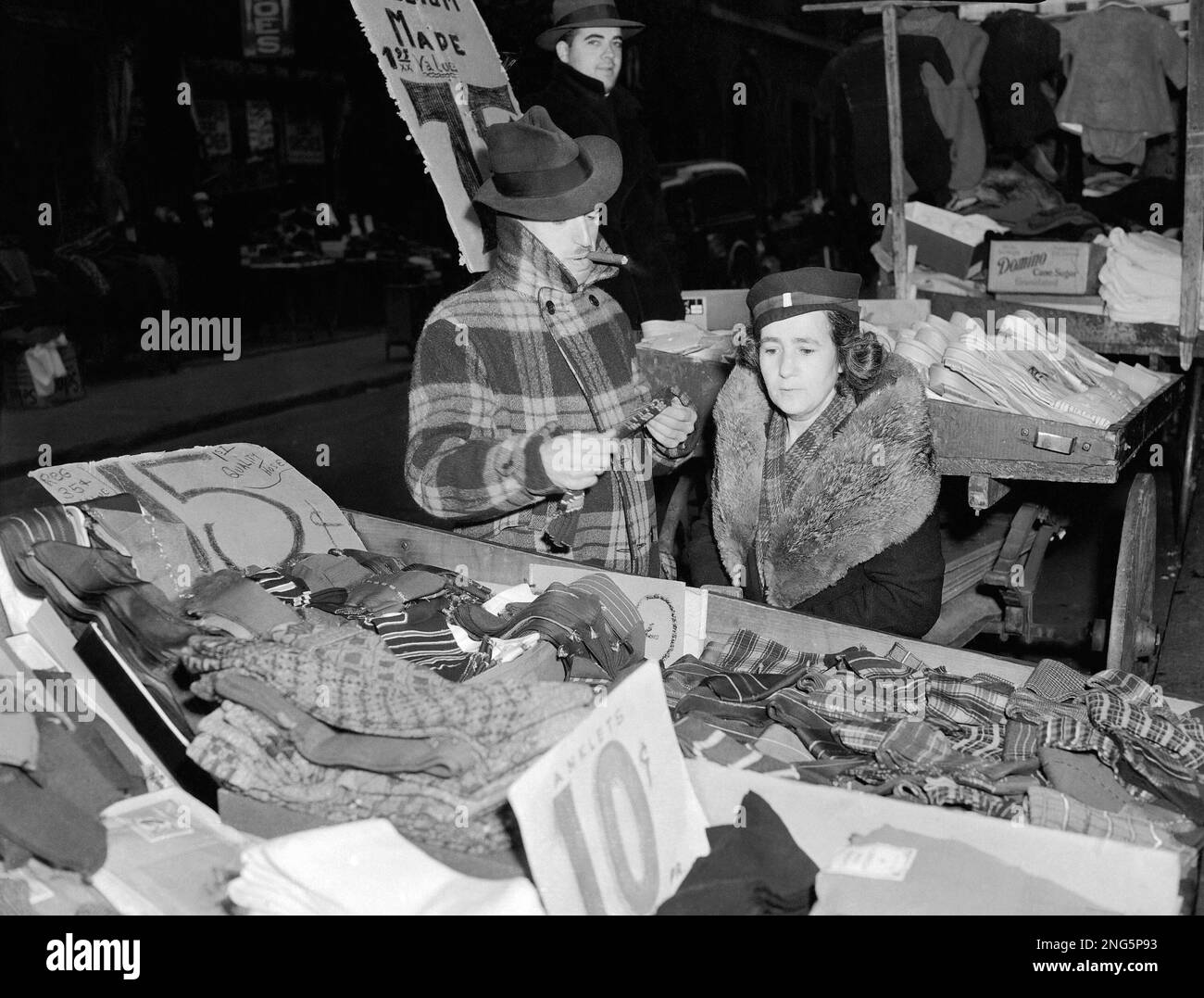A socks sales peddler shown in New York on the famous Orchard Street ...