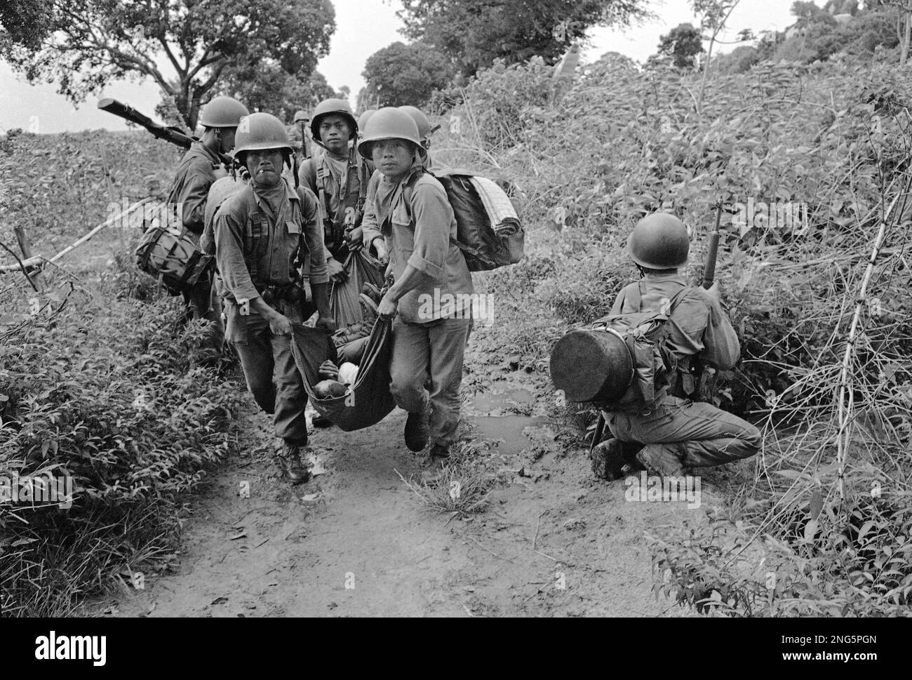 A platoon leader, seriously wounded when he stepped on a mine, is ...