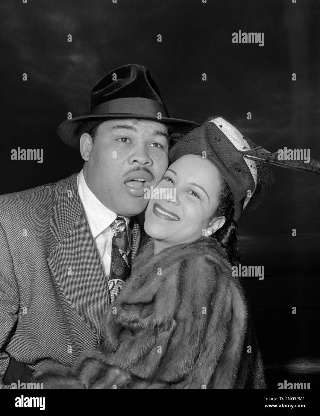 Heavyweight champion Joe Louis is embraced by his wife, Marva April 12 ...