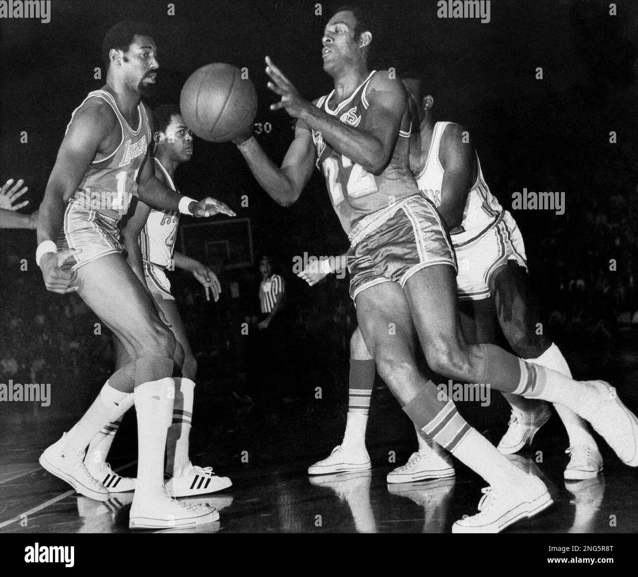 Los Angeles center Wilt Chamberlain, left, passes off to teammate Elgin ...