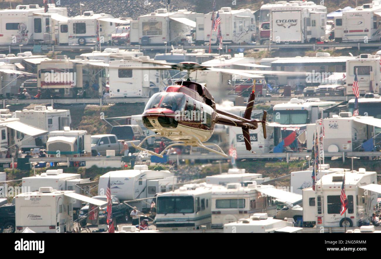 A helicopter carrying a driver arrives near a campground outside ...