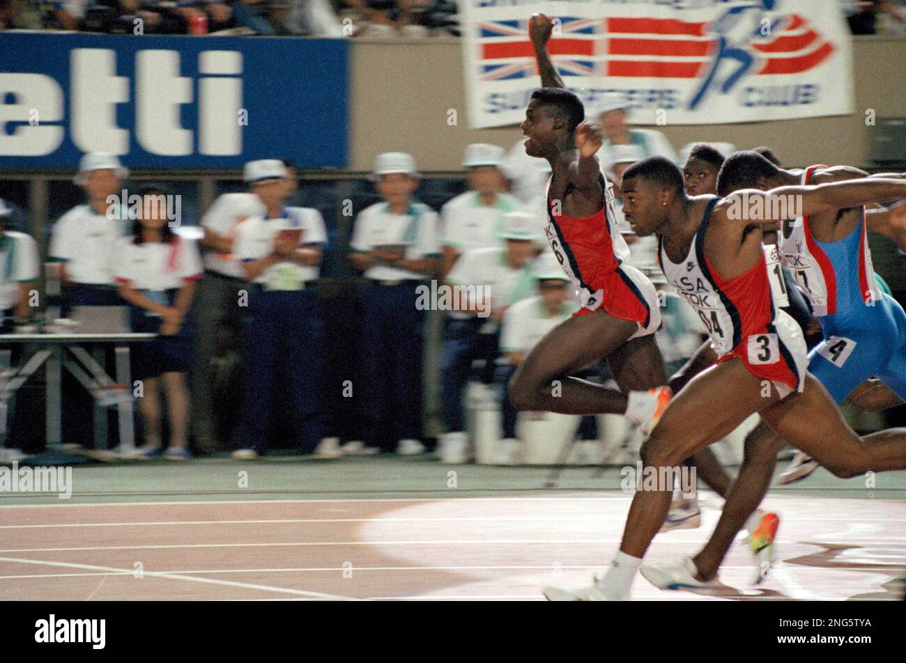Carl Lewis of the United States, left, raises his arms as he crosses ...