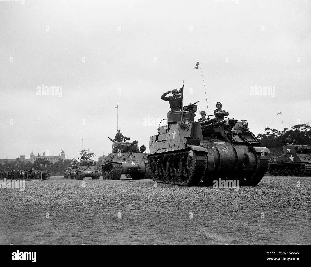 U.S. heavy tanks roll across reviewing ground in May 1946 during a ...