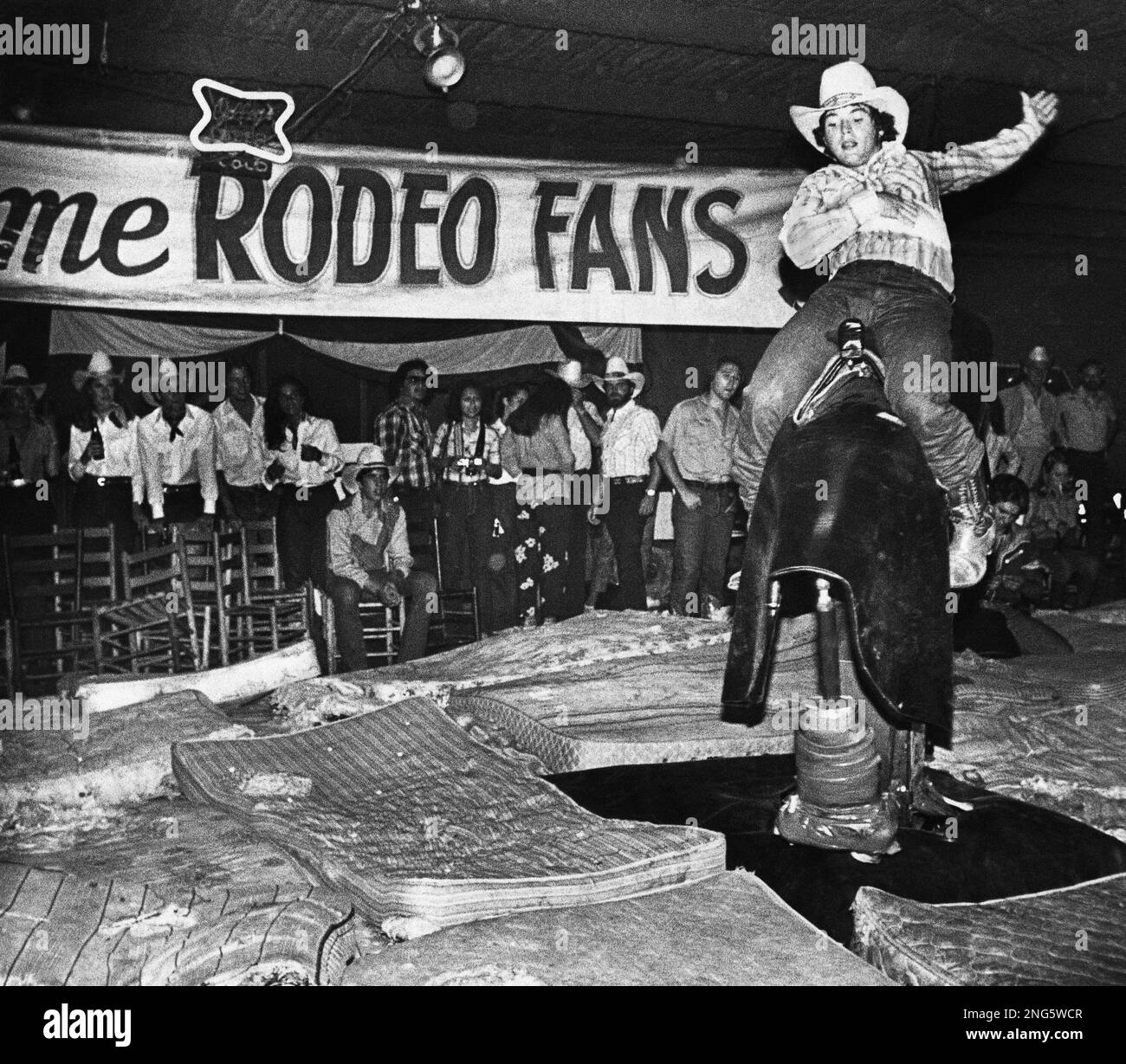 A patron of Gilley's Club ,flings his arm back as he rides the ...