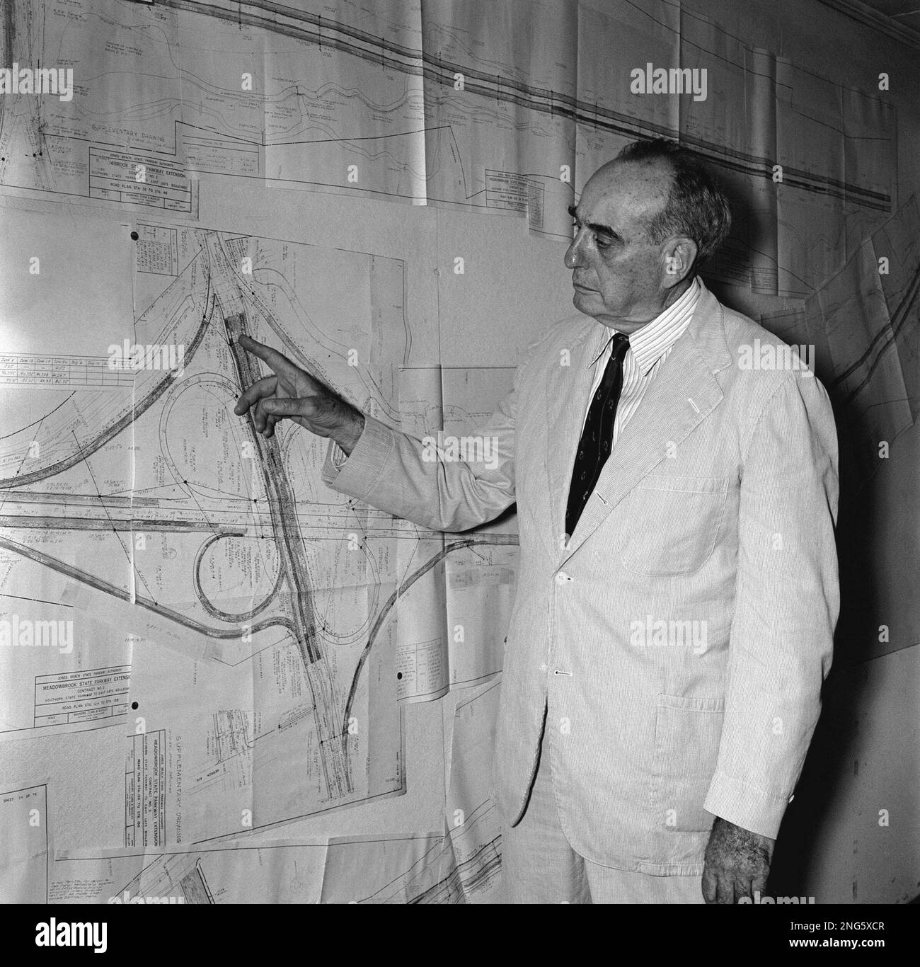Robert Moses, builder, parks, parkways developer, pointing at a map of ...