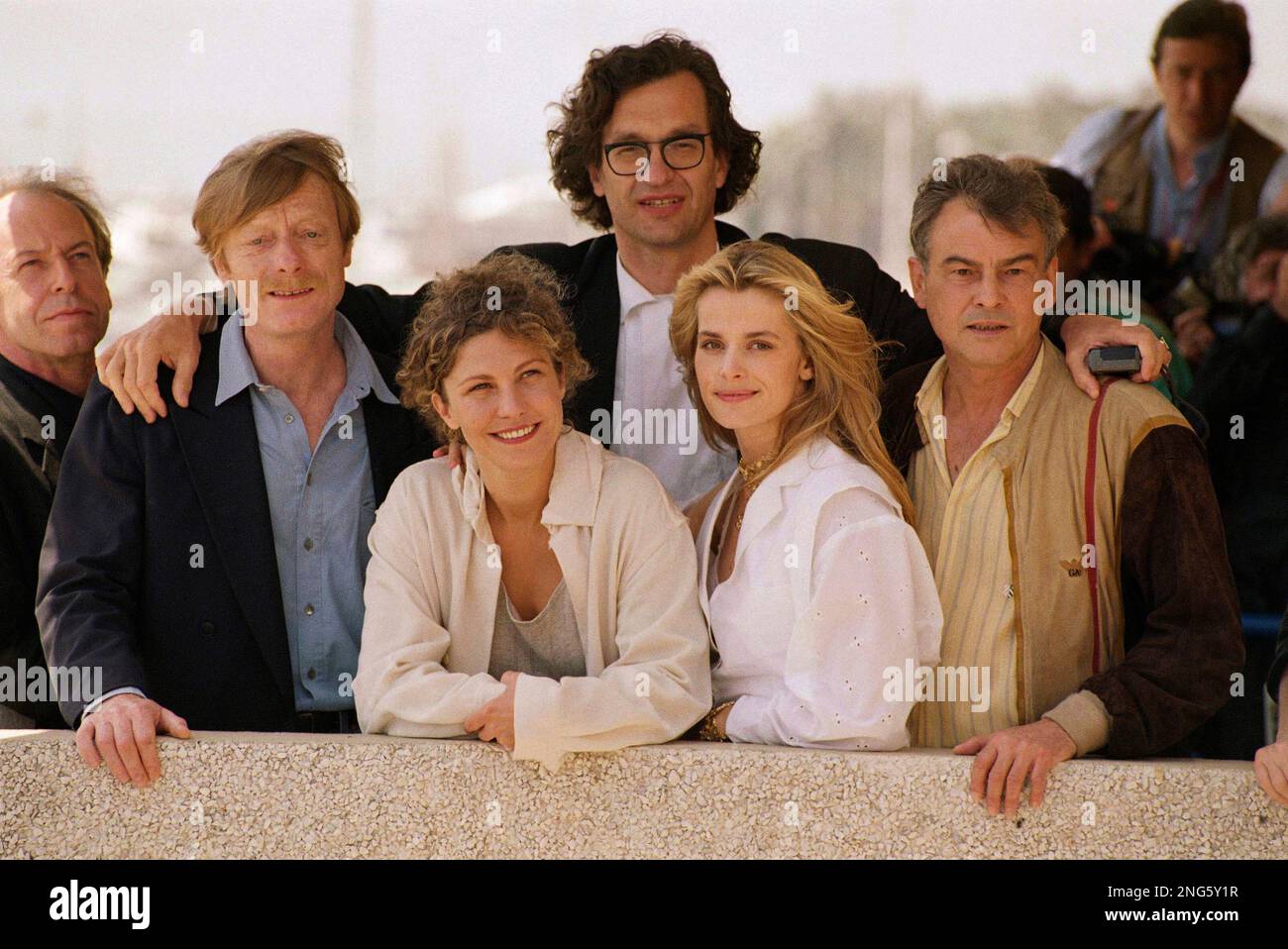 German film director Wim Wenders with his arms around actors from left ...