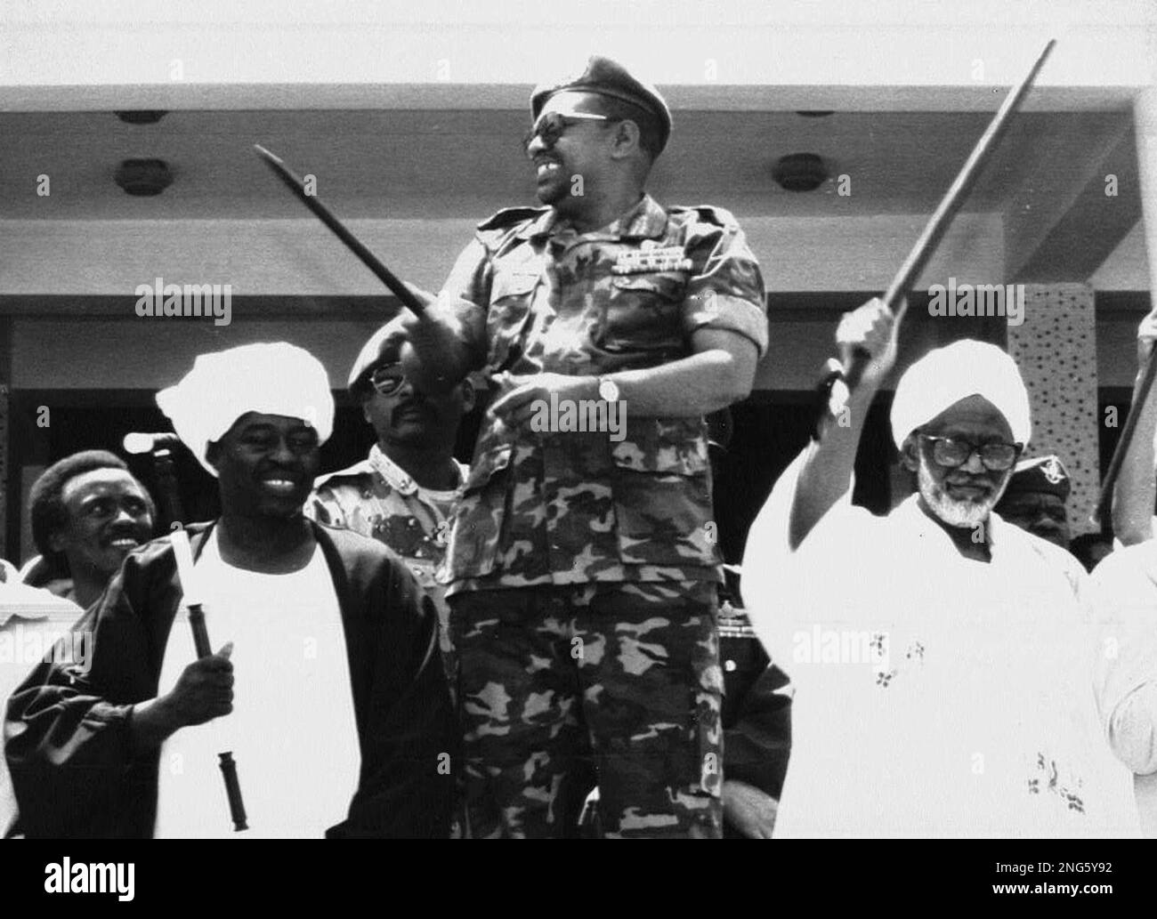 Sudan's military leader Lt. Gen. Omar el-Bashir is flanked by Sudanese ...