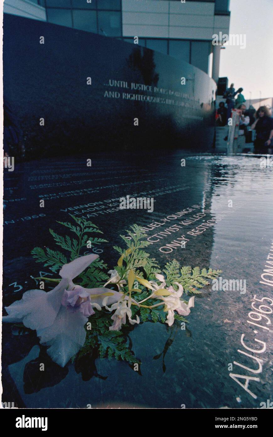 An orchid adorns the name of Samuel Younge Jr., on the black granite ...