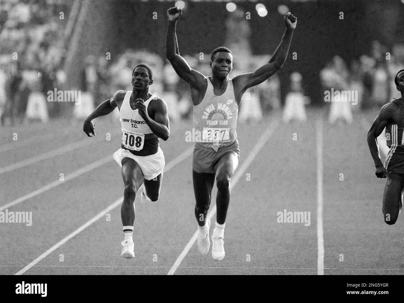U.S. athlete Carl Lewis raises his arms in victory as he wins the 100 ...