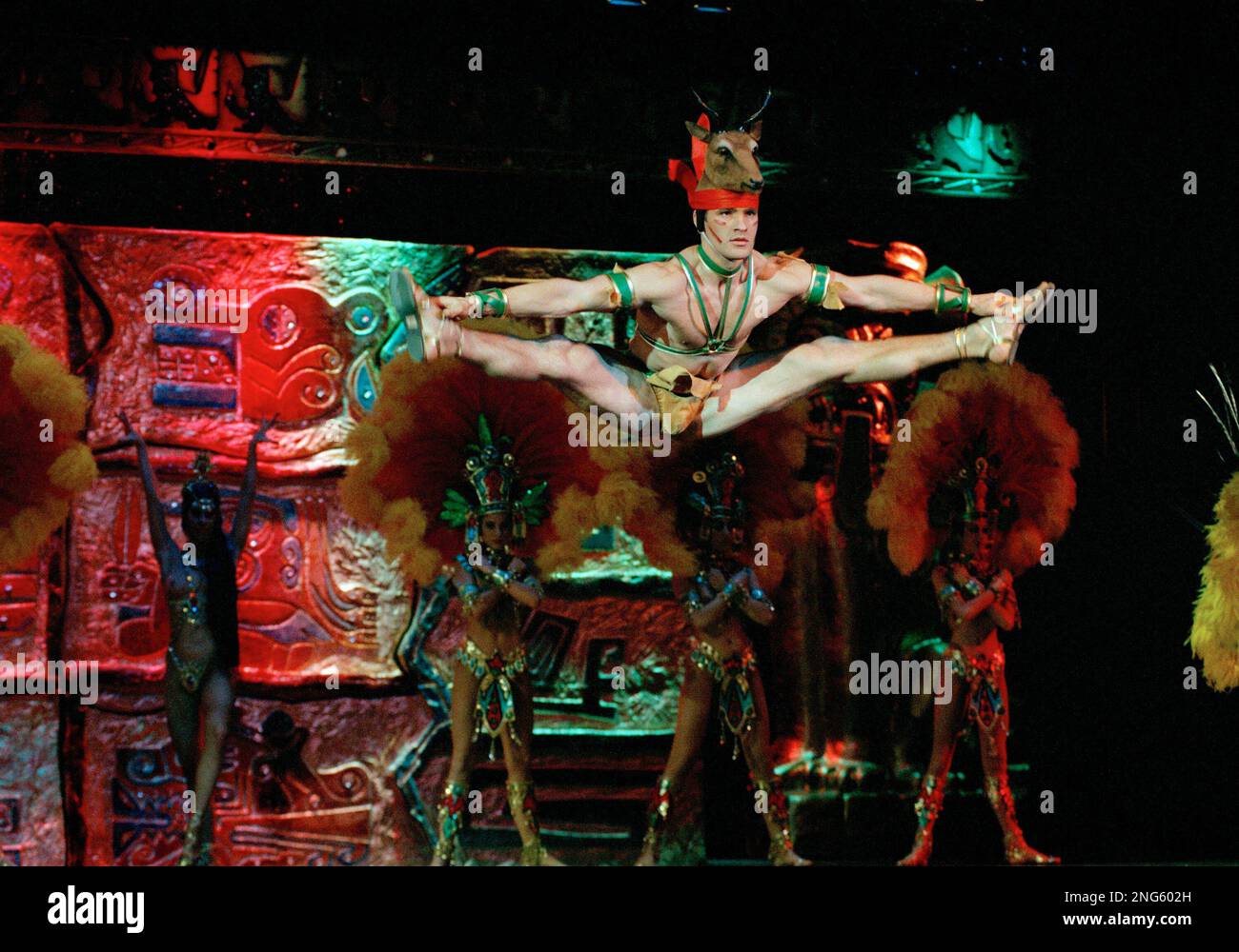 A Lido cabaret dancer flies in the air to do the splits while wearing a gazelle head during the ...