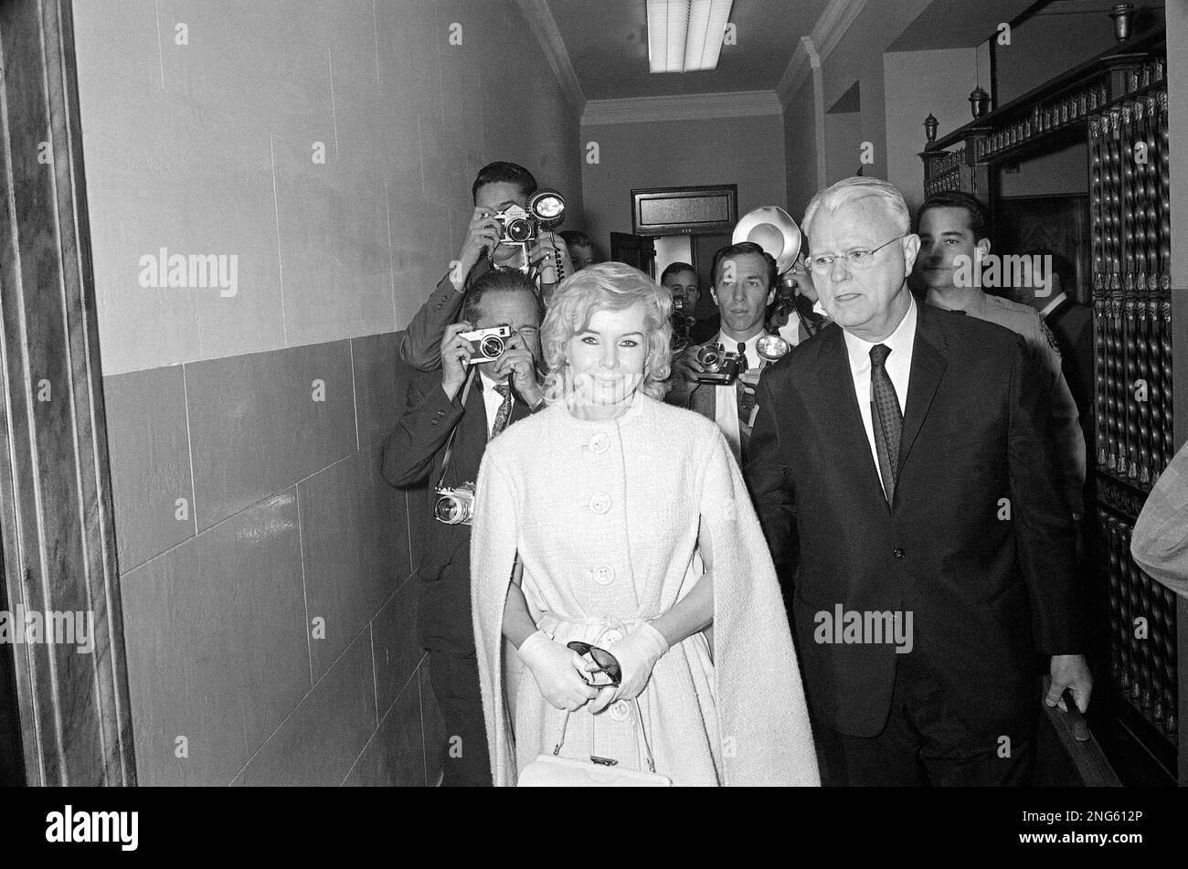 Candace Mossler smiles as she makes her way through news cameramen ...