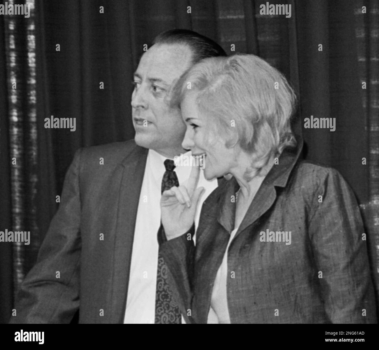 Candace Mossler smiles and holds a finger to her mouth as she and her ...