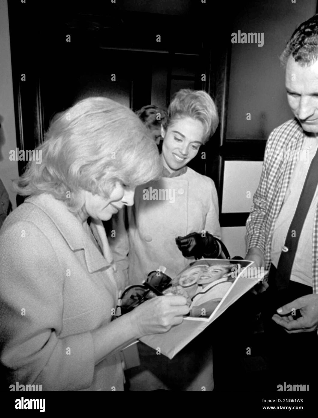 Candace Mossler autographs a picture of herself and Marian Rosen, her ...