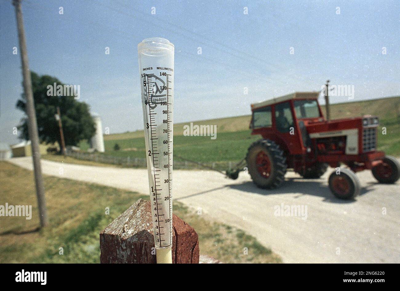An empty rain gauge sticks up from a post on a farm in Marne, Iowa ...