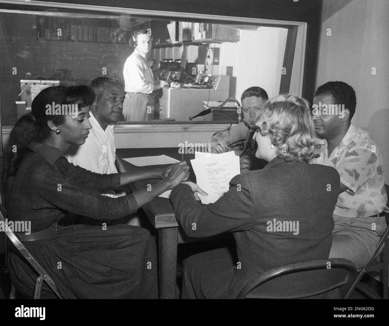 A mixed African-American and white group meet in a forum to discuss ...