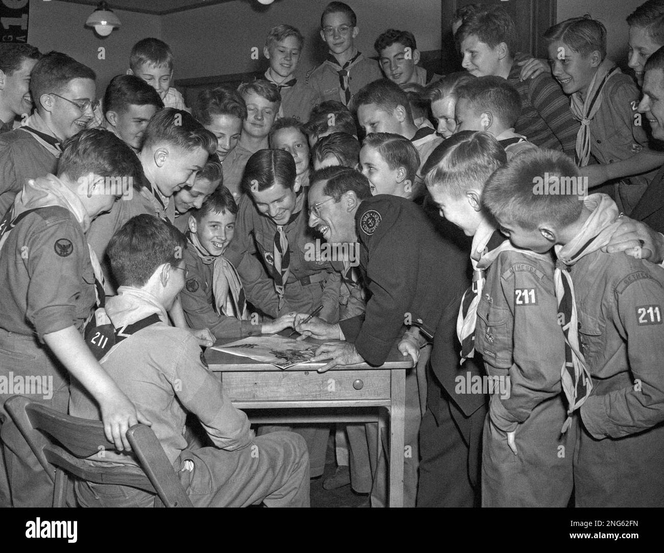 Members of Boy Scout Troop 211 gather around Associated Press photographer Joe Rosenthal in ...