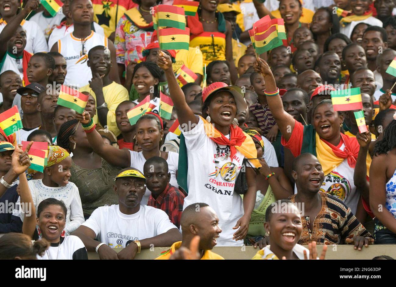People wave flags during a celebration to mark Ghana's 50 years of ...