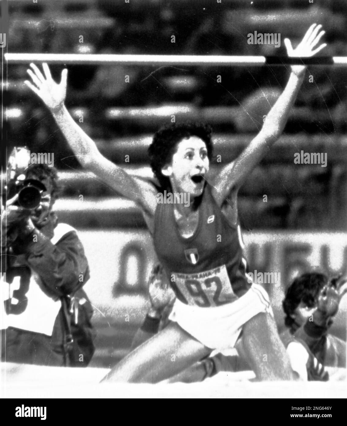 An exultant Italian athlete Sara Simeoni, kneels on the mat with arms ...