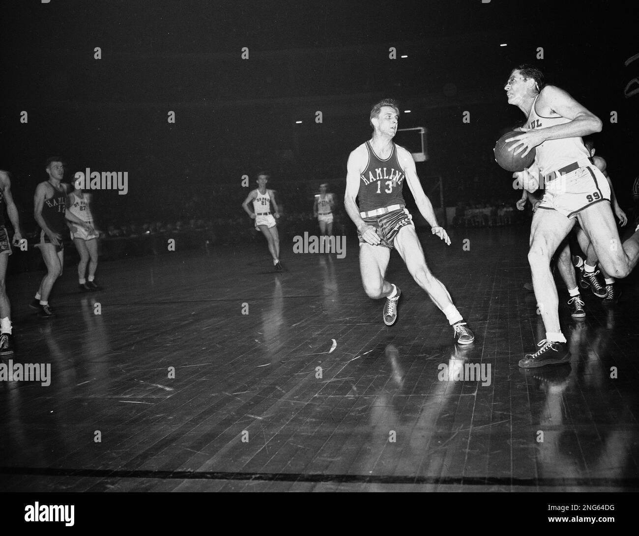 DePaul's George Mikan (99), with the ball is guarded by Hamlie's Howie ...