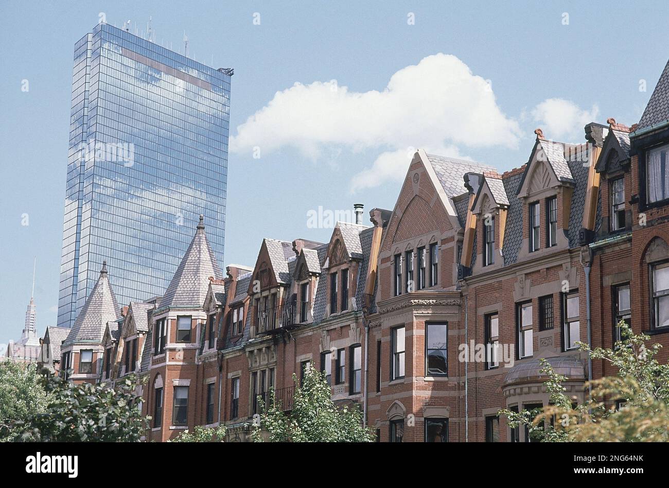 A highrise building towers over a row of traditional brownstone houses ...