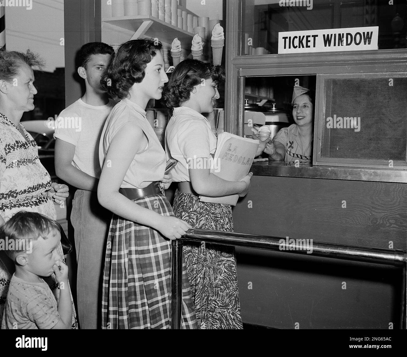 Customers stand at the "ticket window" June 12, 1952 which is one of ...