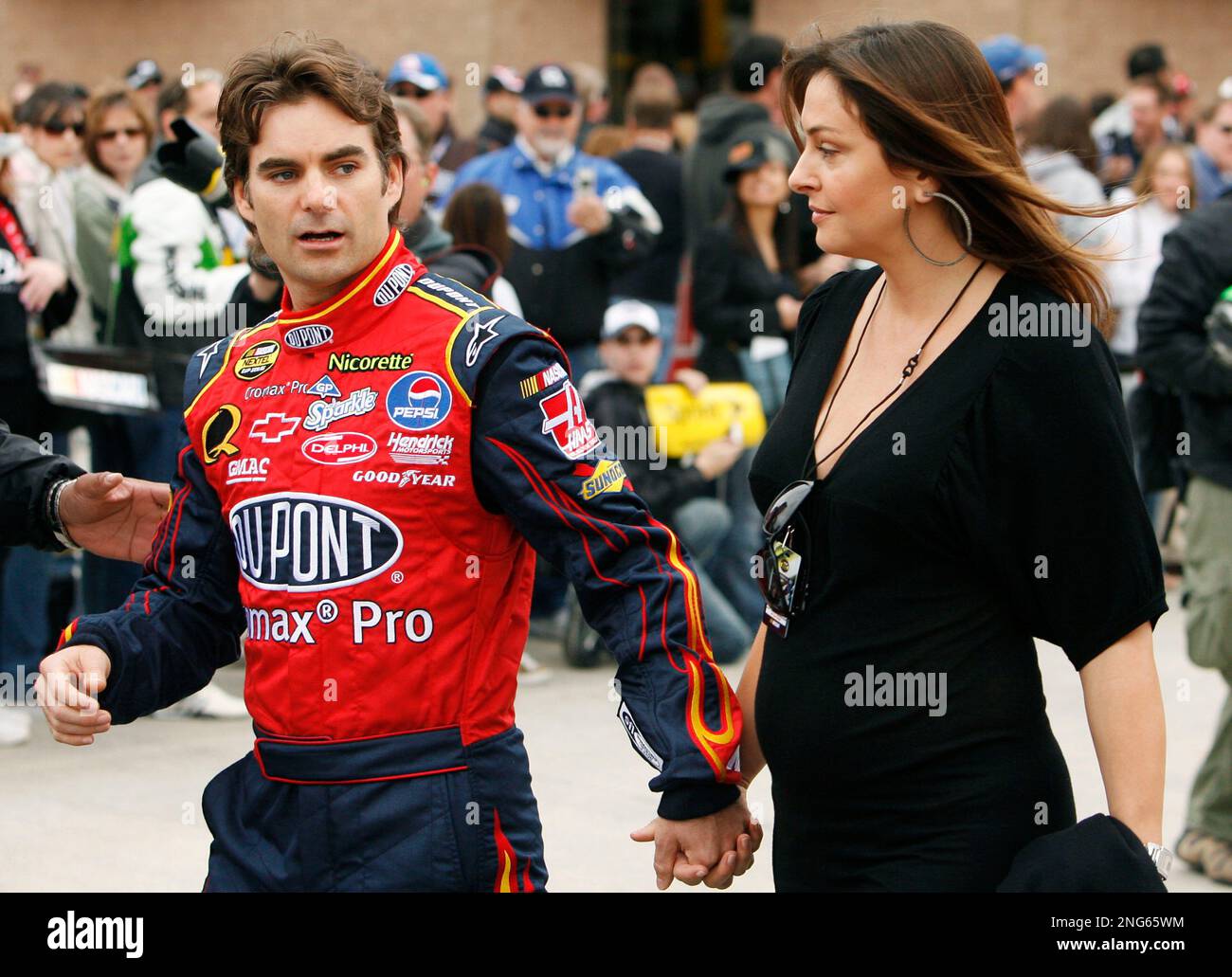 Driver Jeff Gordon, left, and his wife Ingrid Vandebosch walk through ...