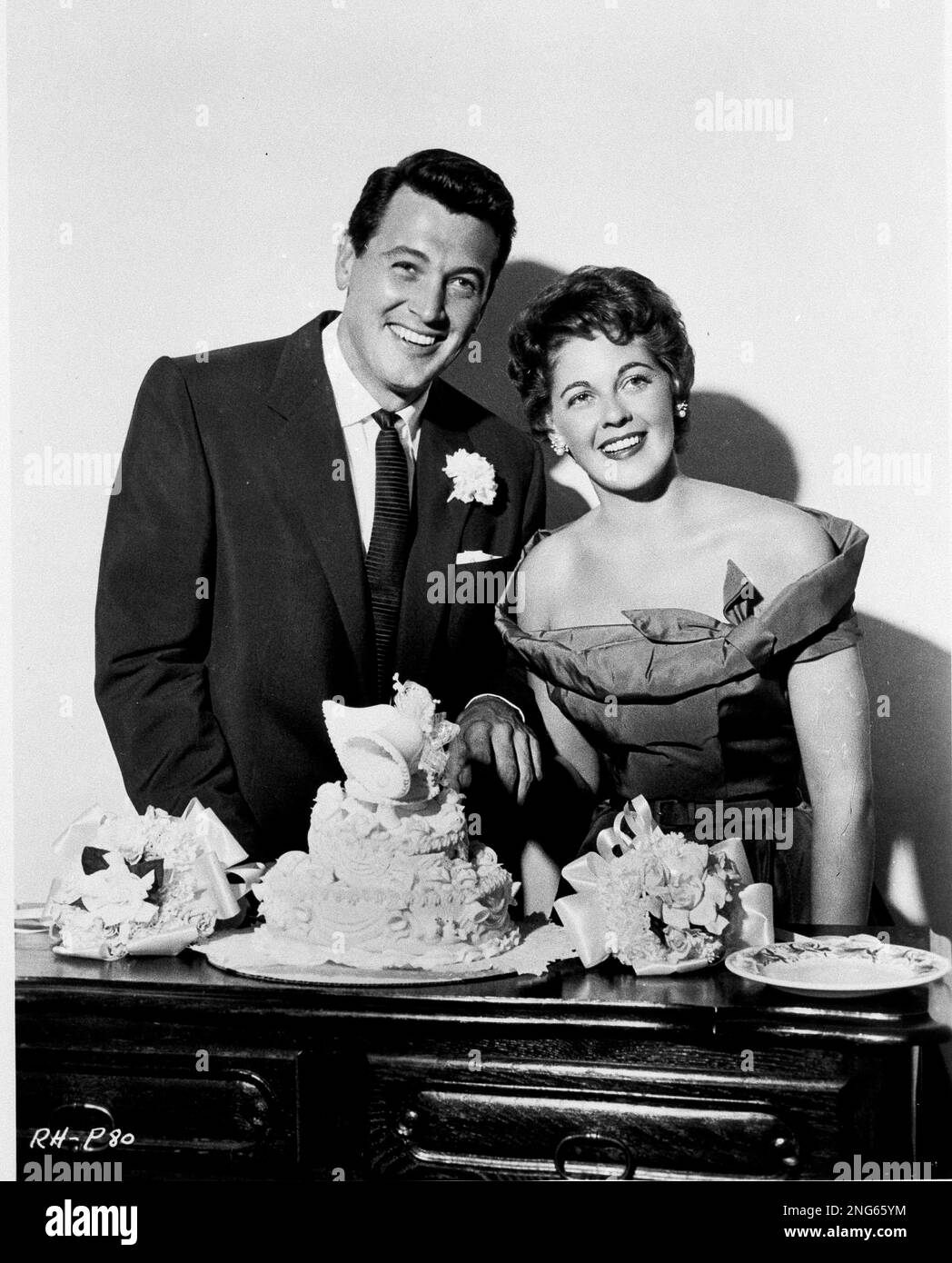 Rock Hudson and his bride, the former Phyllis Gates, cut their wedding ...