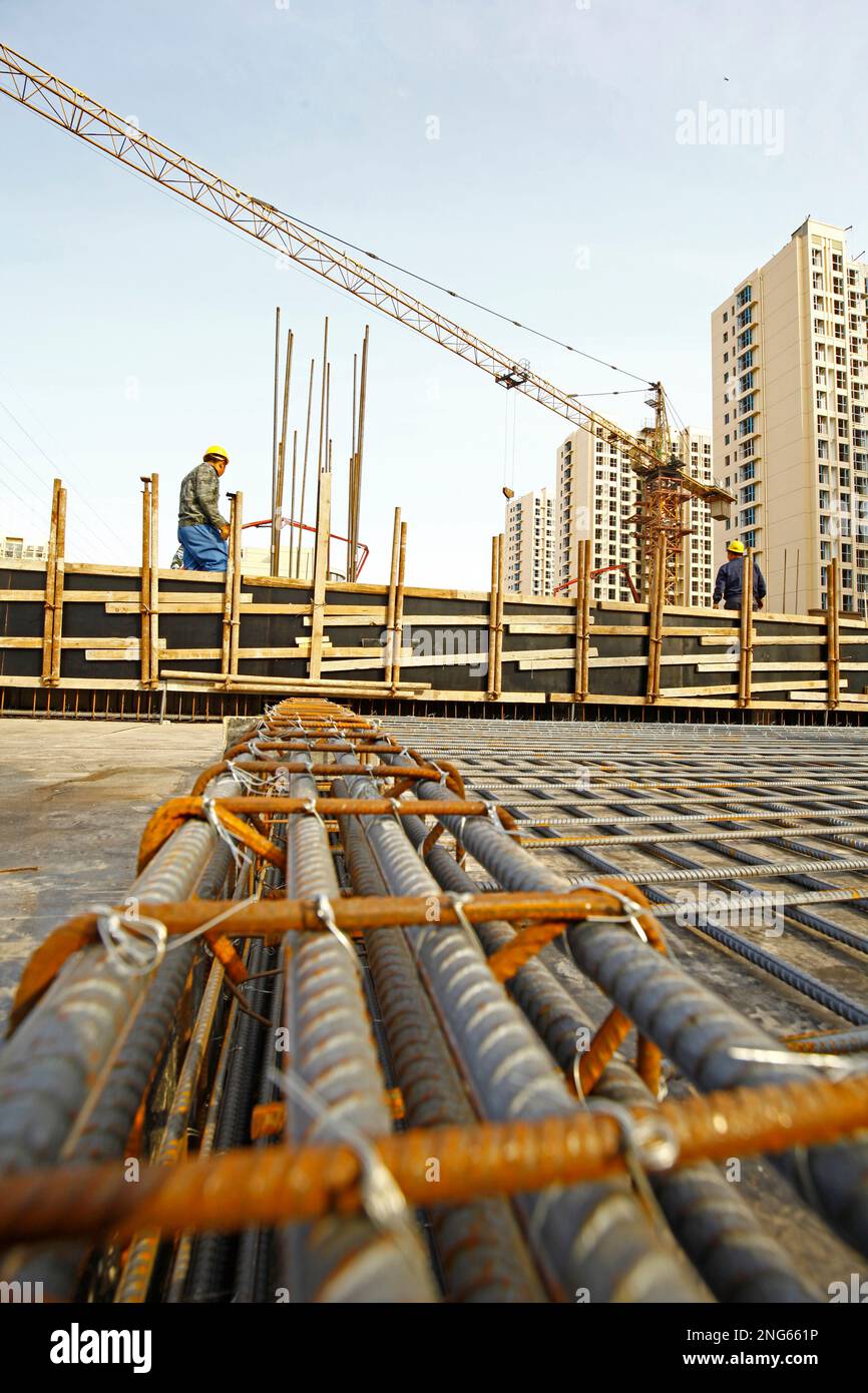 worker in the construction site making reinforcement metal framework ...