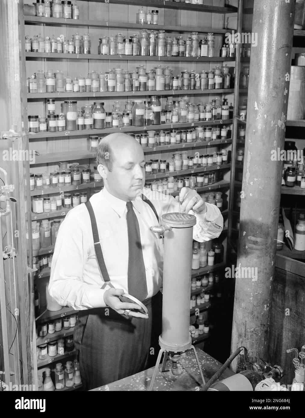 Dr. Melvin Calvin is seen with part of his oxygen-producing equipment ...